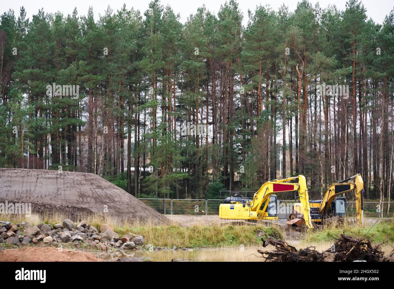 Construction site digger yellow during excavation on building site ...