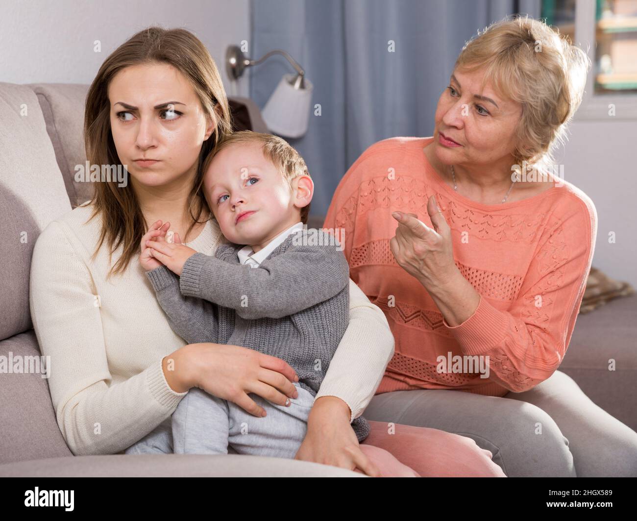 Two adult female are having disagreements with upbringing kid Stock ...