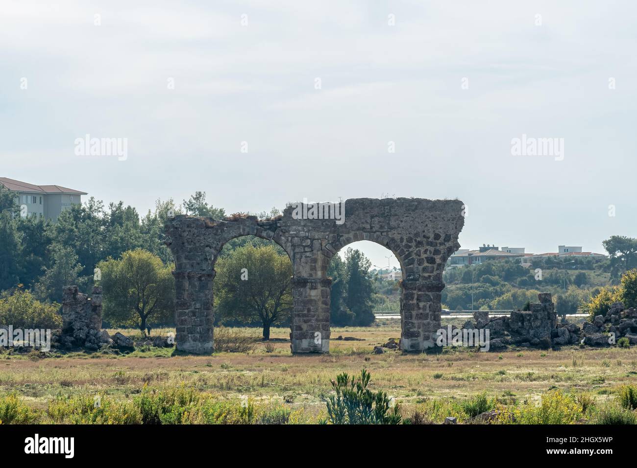 Ruin of an ancient Roman aqueduct in a city wasteland near the ancient ...