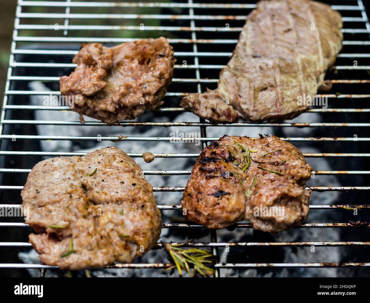 pieces of meat on the grill of a barbecue Stock Photo - Alamy