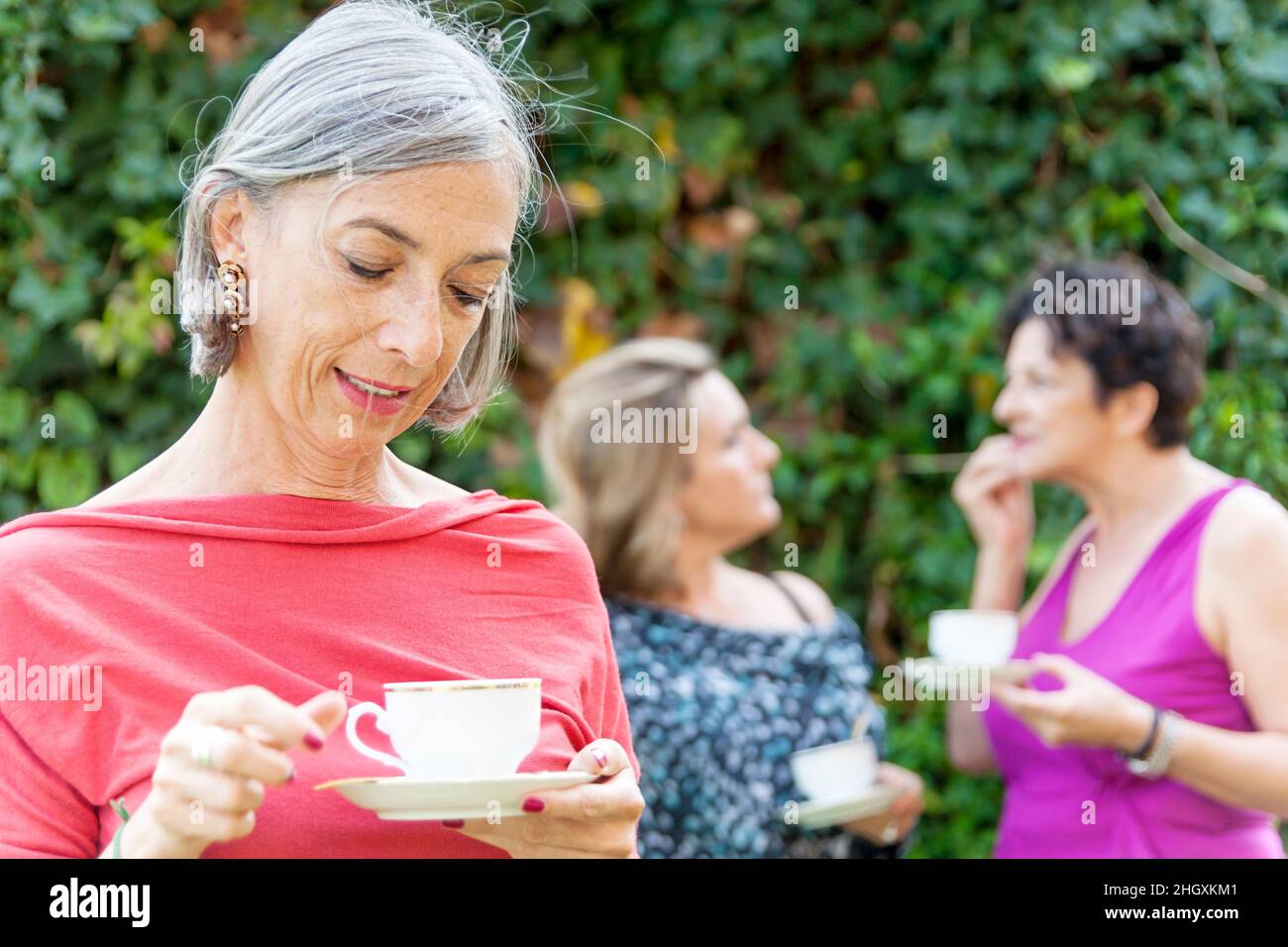 lady drinking a cup of tea with friends Stock Photo - Alamy