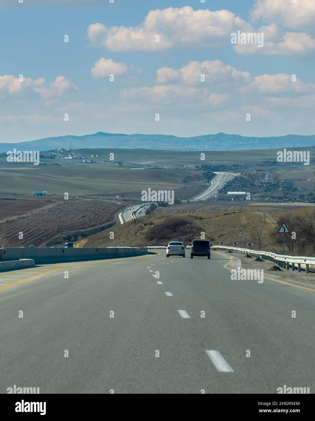Curving asphalt road between Baku and Shamakhi districts and hills in ...