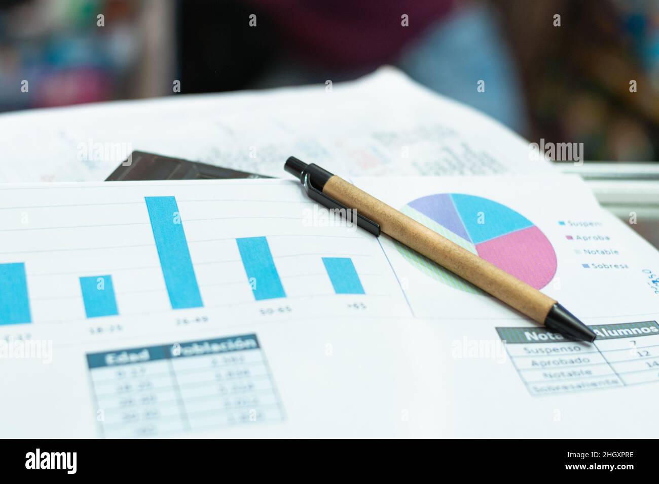 eco-friendly cardboard pencil. on top of a sales chart, abandoned due ...