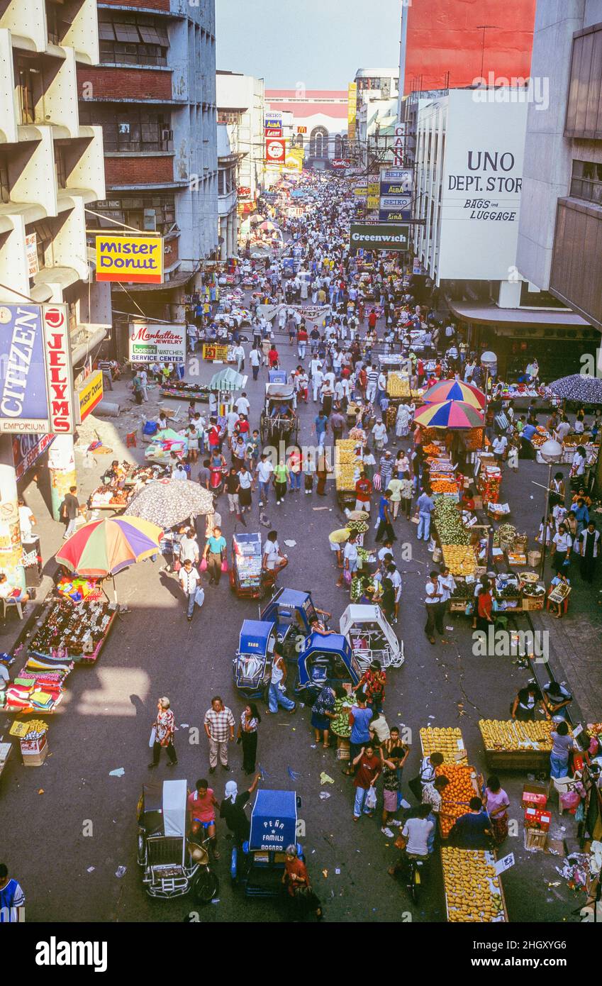 A busy streetscene of retail shopping outlets and market stalls on ...