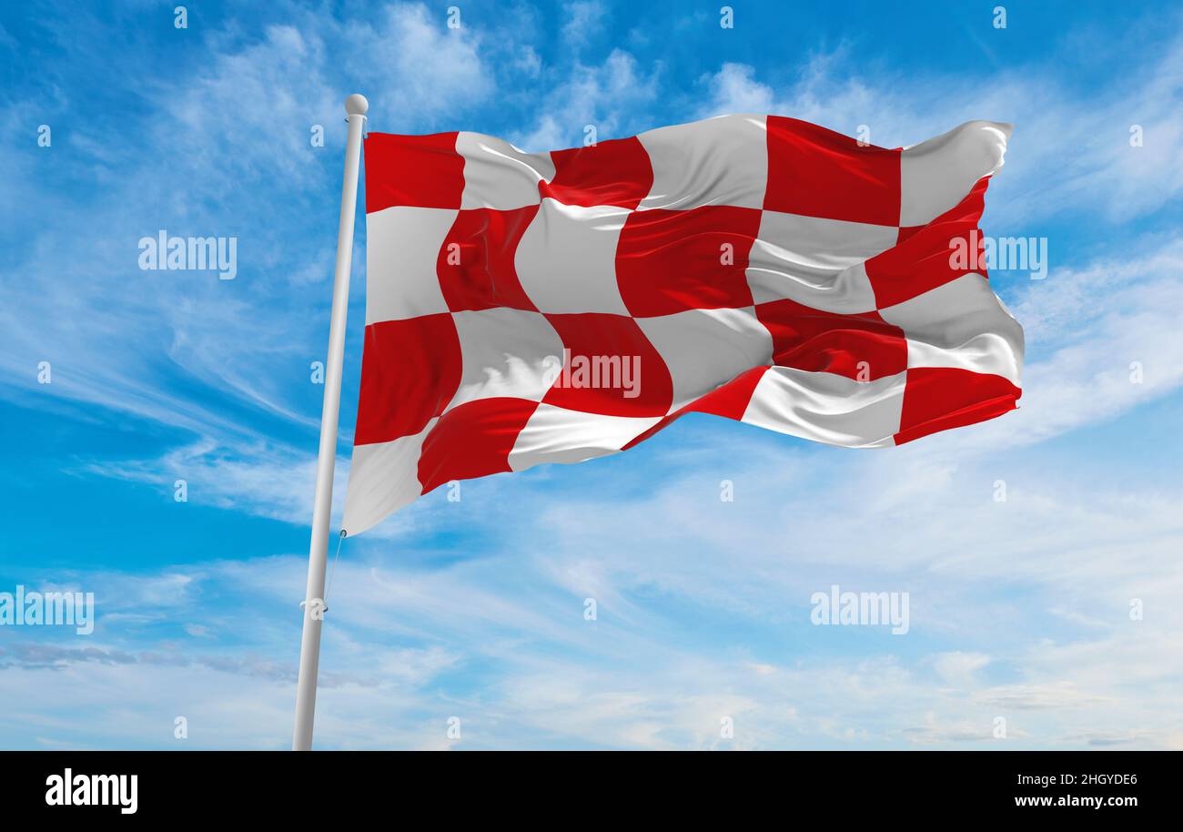 flag of North Brabant , Netherlands at cloudy sky background on sunset ...