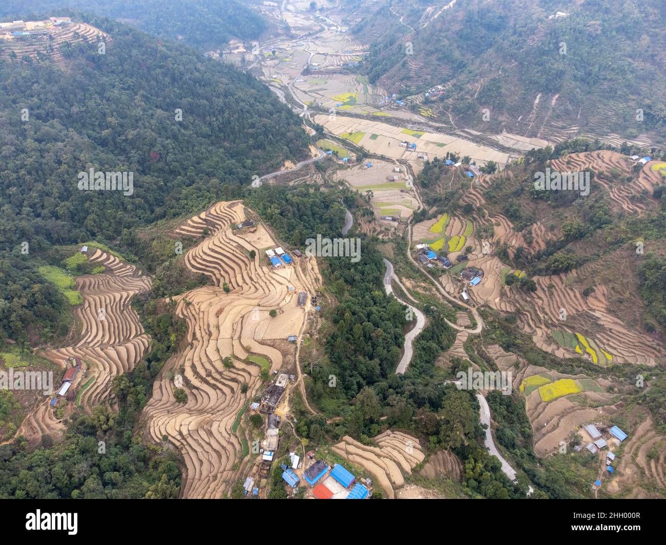 An aerial view of terraces and fields on a hillside in Nepal Stock ...