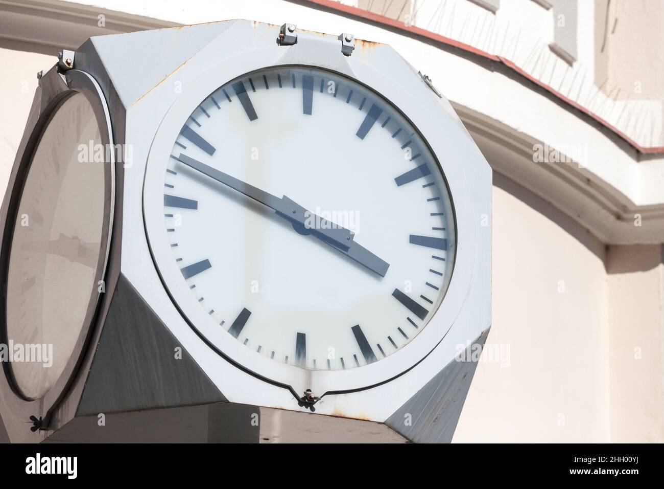 Picture of a public clock in an urban street, indicating precisely the ...