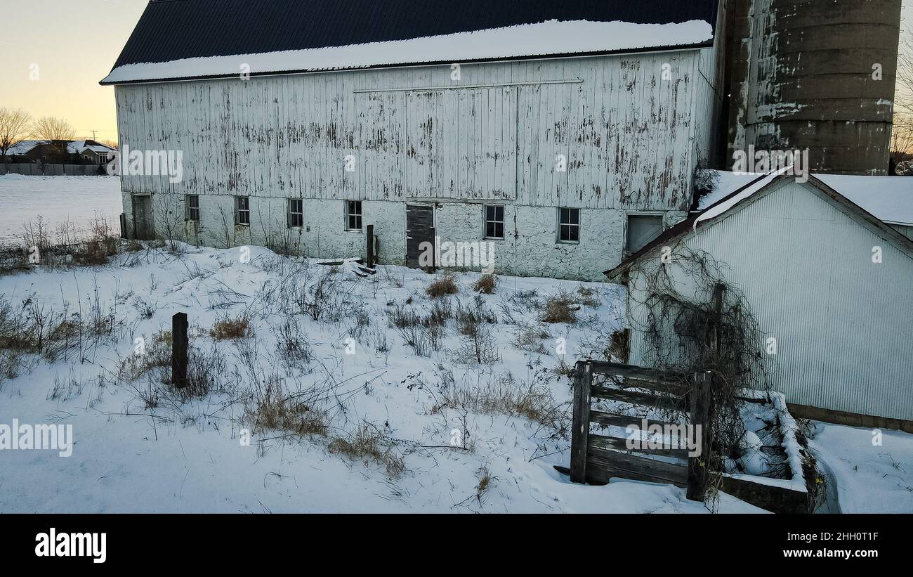 Snow covers the ground around the old barn Stock Photo - Alamy