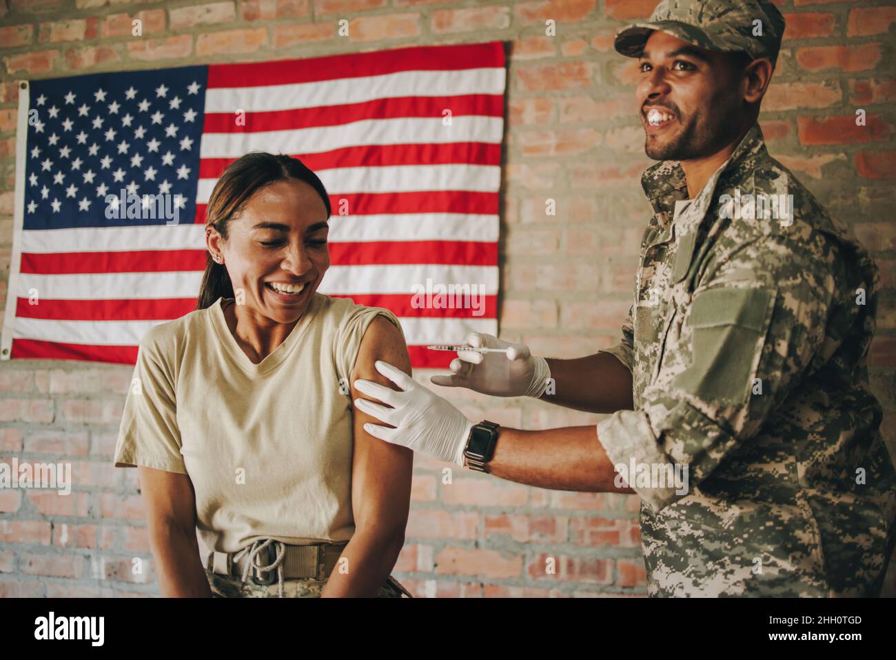 American military doctor inoculating a female soldier with a dose of ...