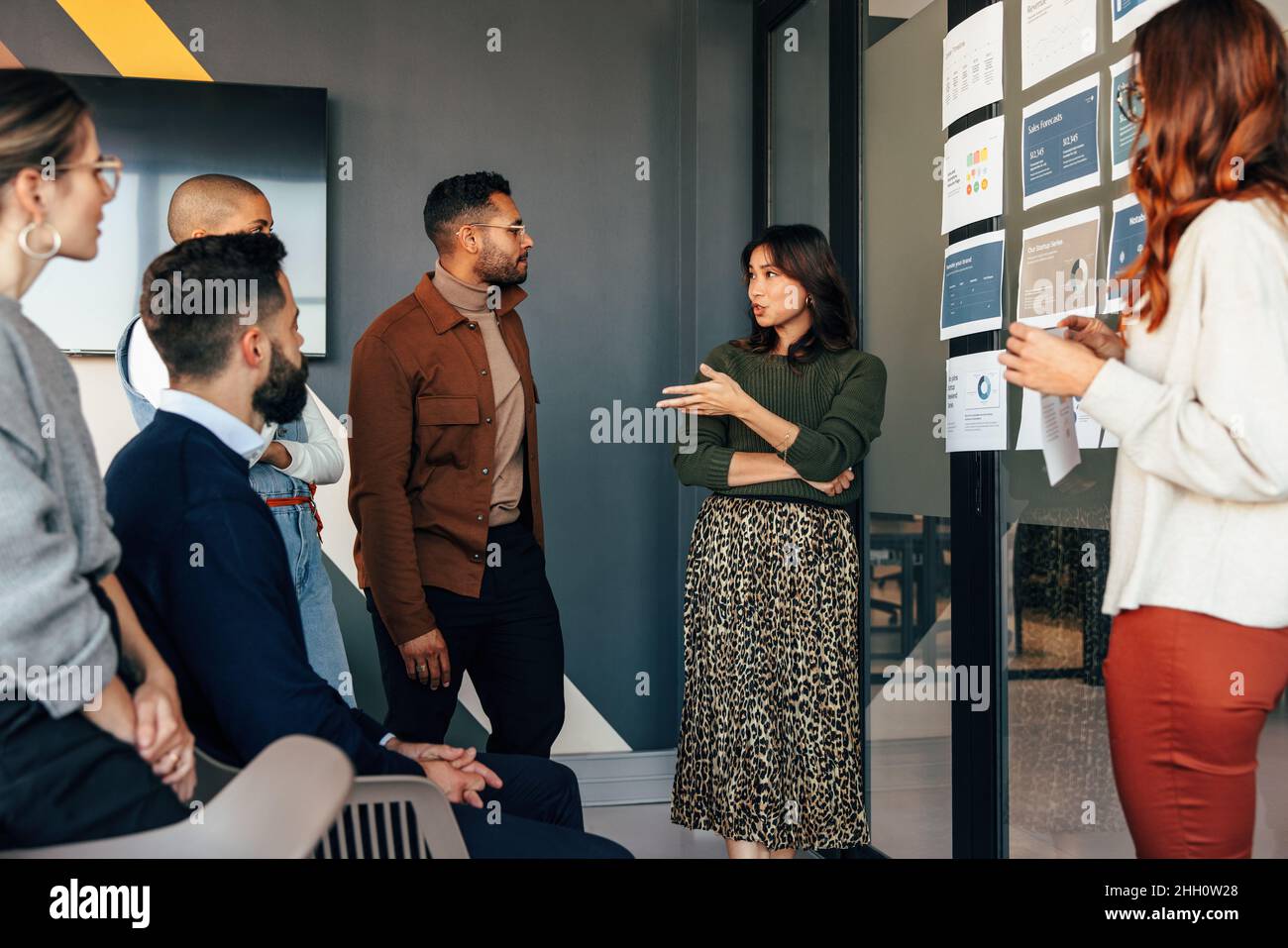 Female manager having a discussion with her business team. Group of ...