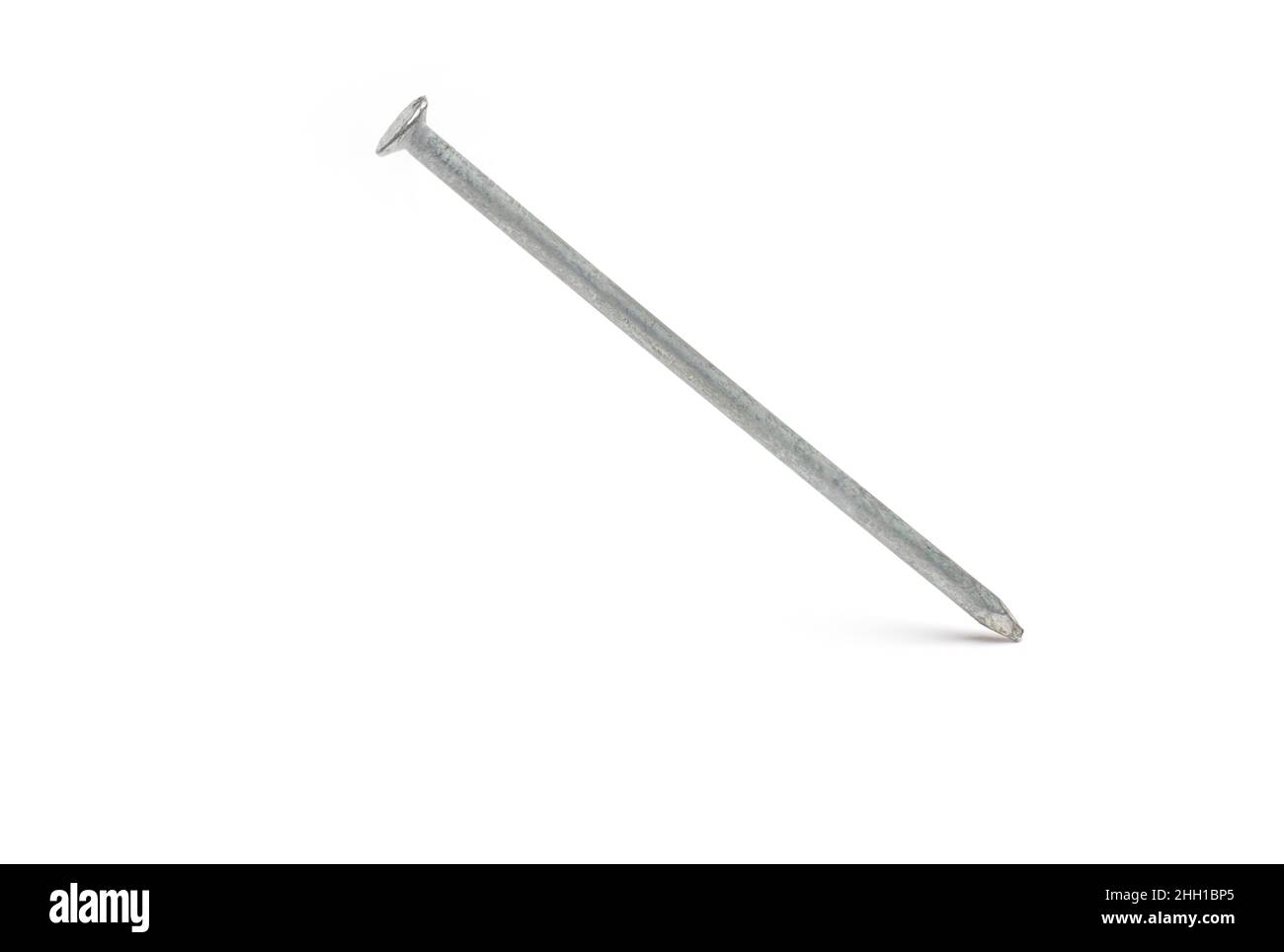 Closeup of galvanized steel nail with flat head on white background ...