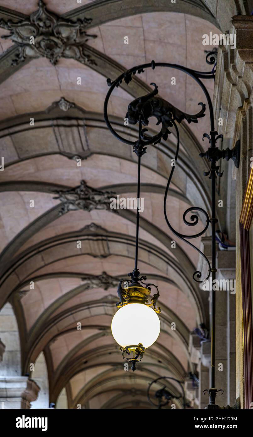 Baroque style covered arcade and ornate metal art nouveau light fixture ...