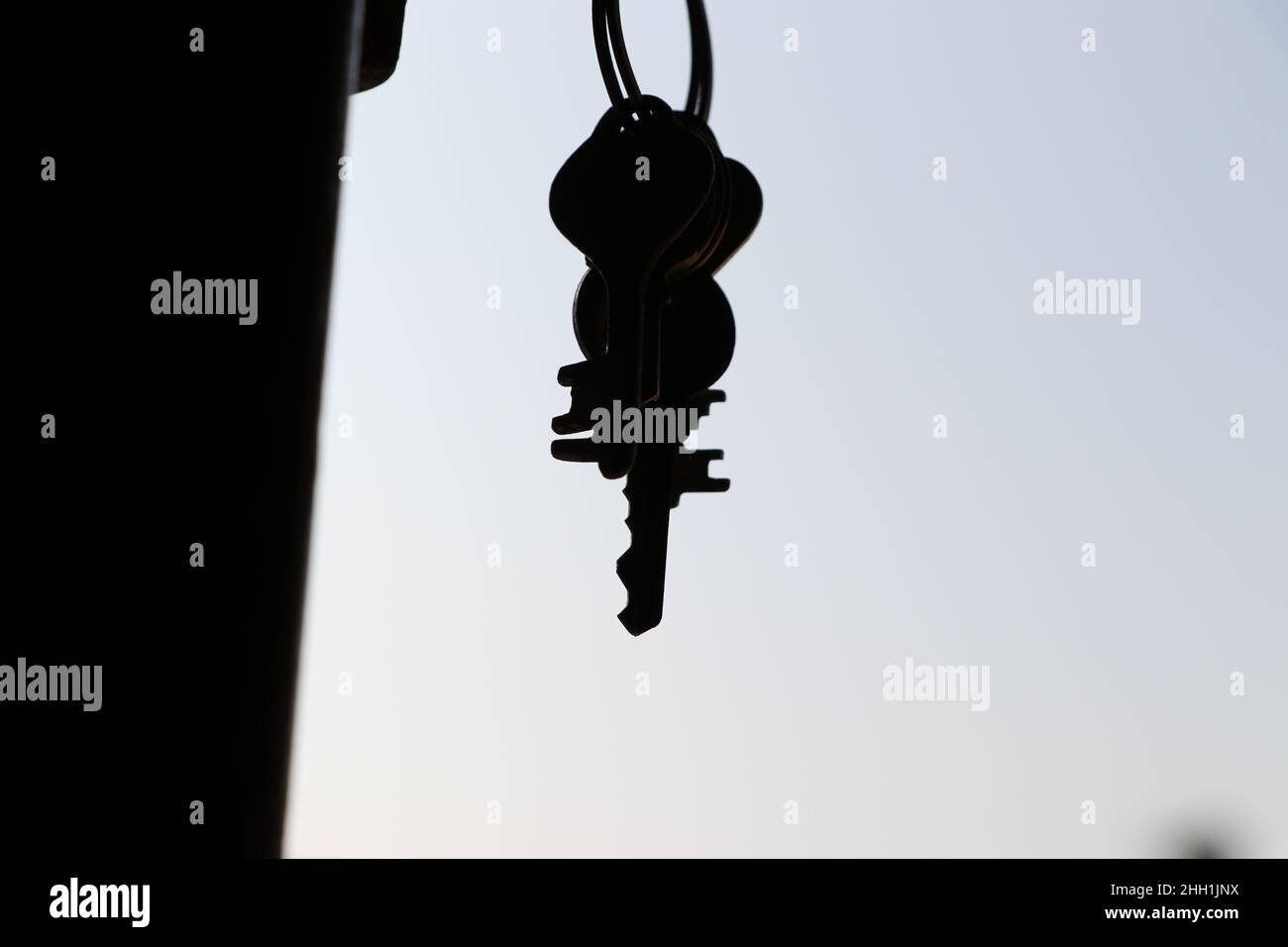 key hanging on door lock Stock Photo - Alamy