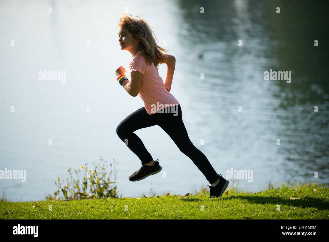 Kid runners in park. Sporty young child jogging and training outdoor ...
