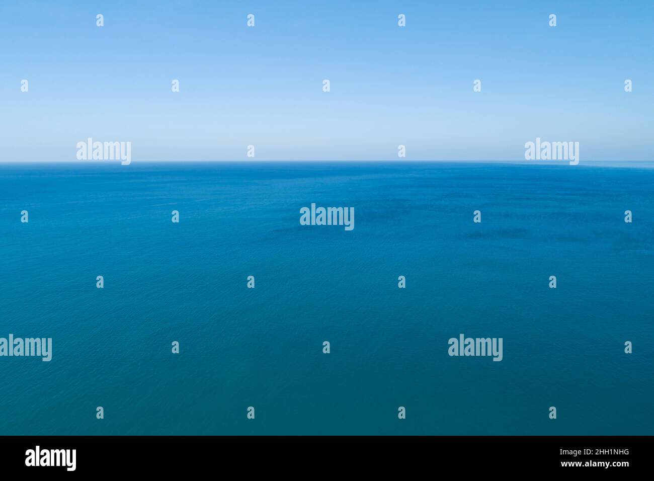 Aerial view of a blue sea surface water texture background and sun ...