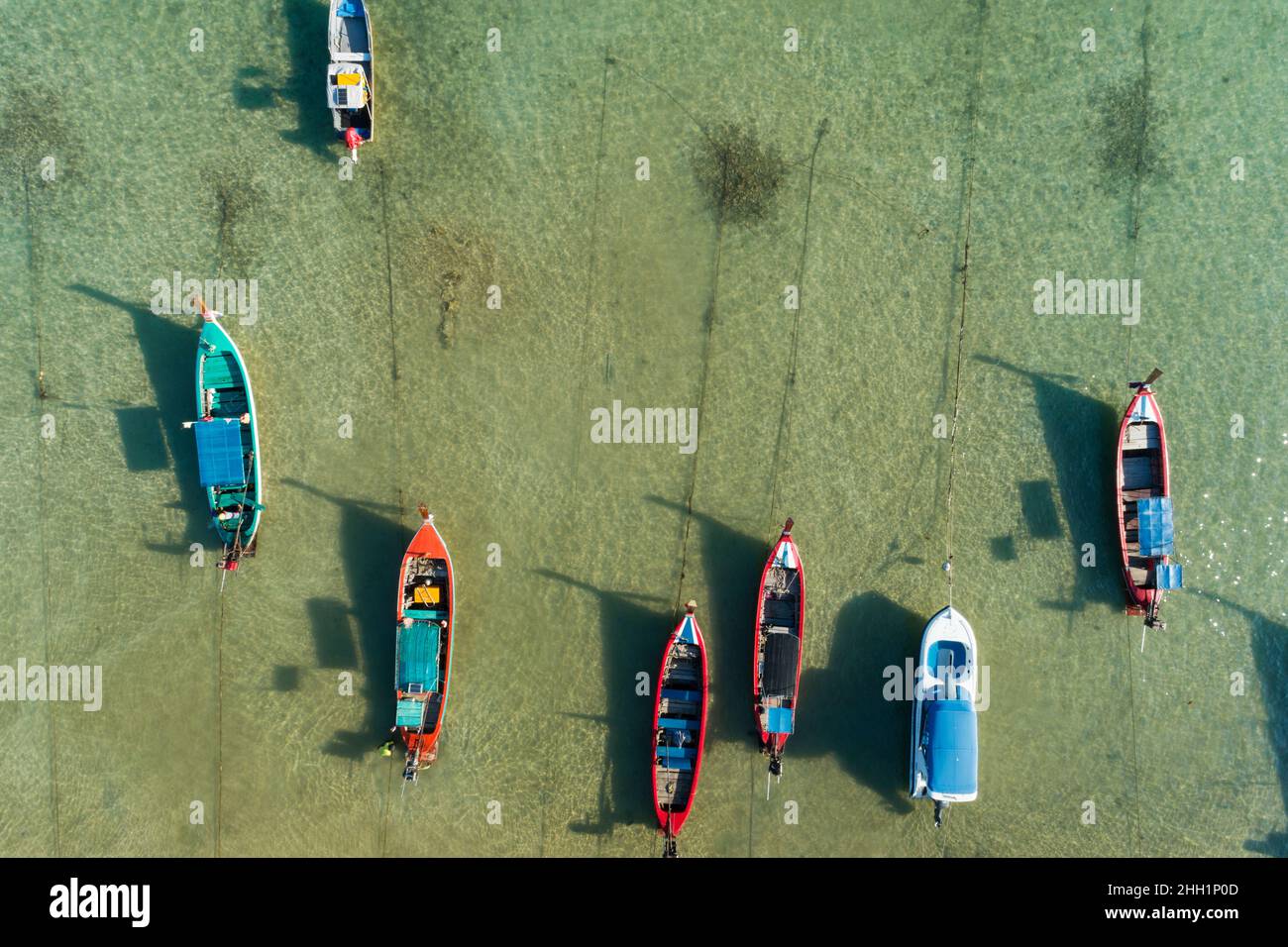 Aerial drone bird's eye view photo Top down of tropical sea with long tail fishing boats Travel ...