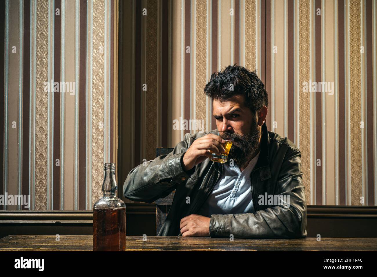 Upset man drinker alcoholic with glass drinking whiskey alone, sad ...
