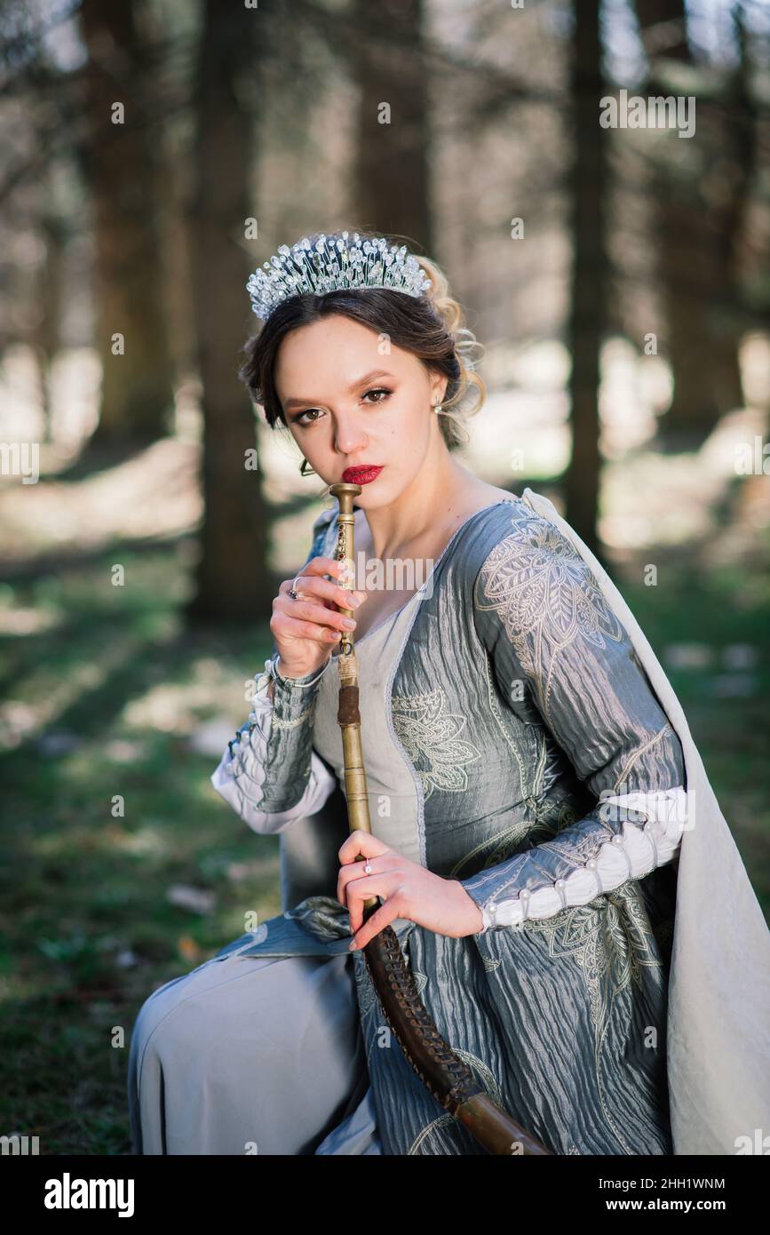 Actress in medieval costume with musical instrument horn during ...