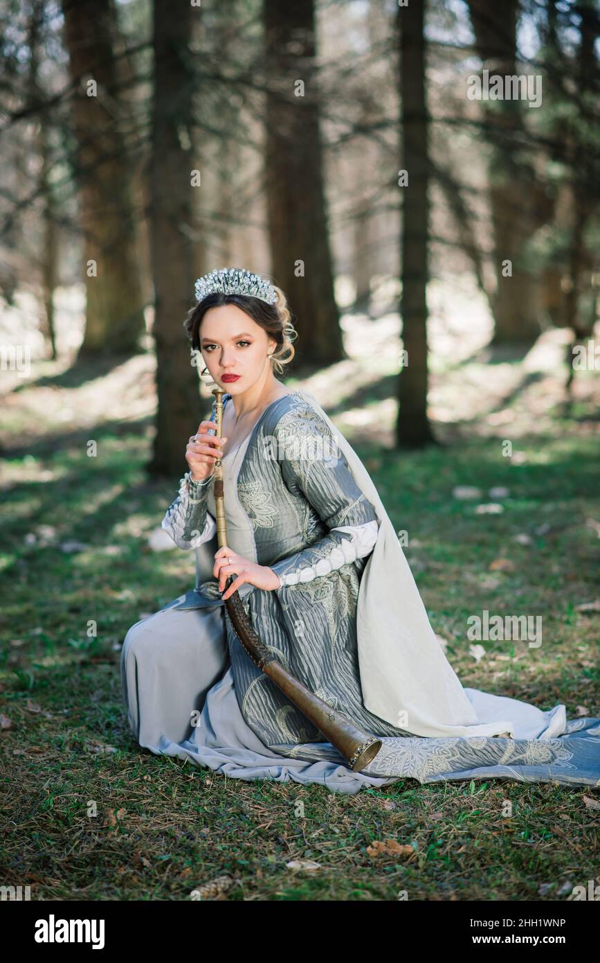 Actress in medieval costume with musical instrument horn during ...
