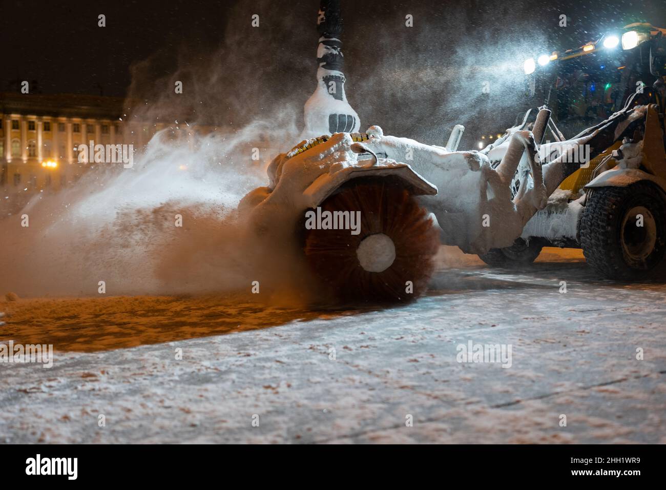 Winter service vehicles. Big yellow snow plow tractor working in city ...