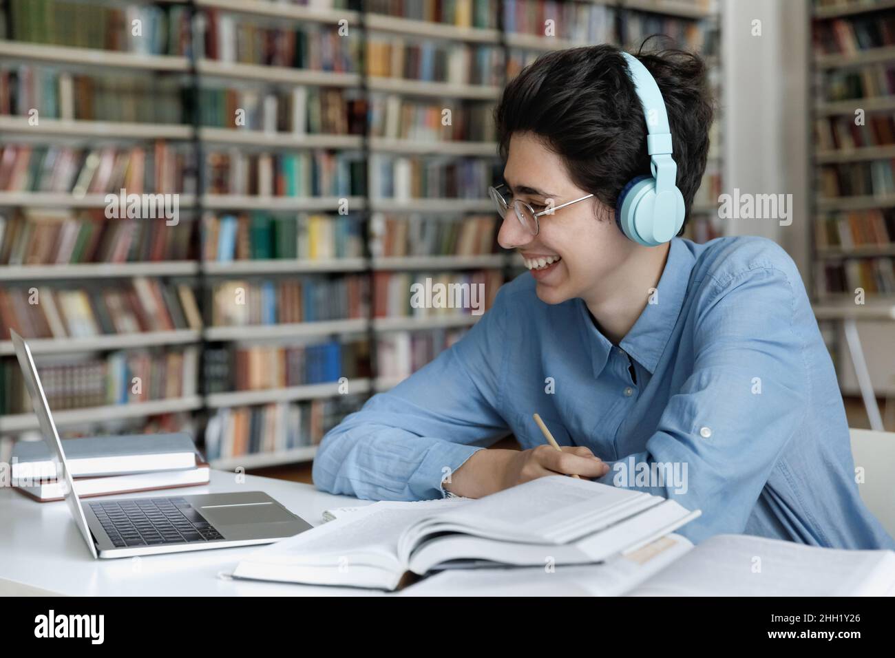 Happy engaged high school, college student in bright wireless ...