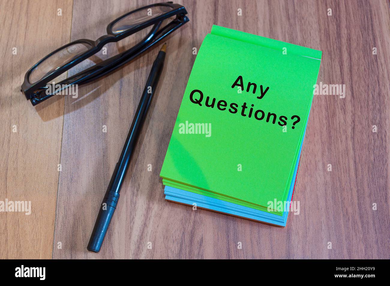 Any question with punctuation mark text on green notepad with glasses ...