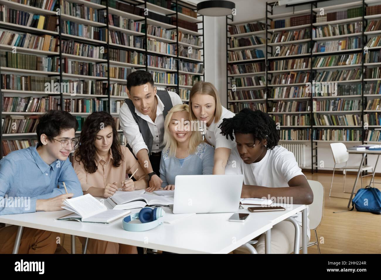 Multiracial group of students watching online learning presentation ...