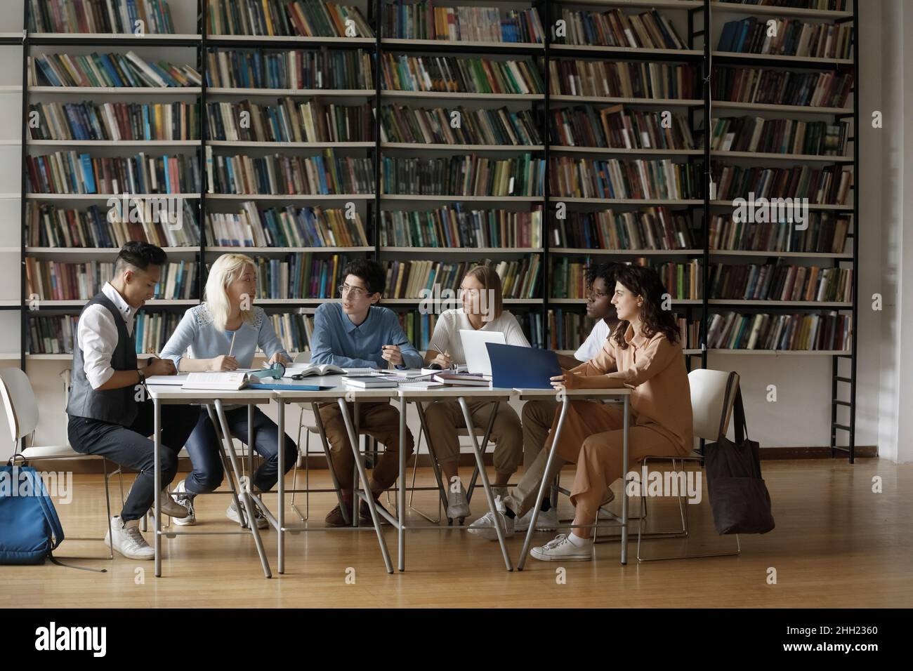 Diverse multiethnic group of students cooperating on graduation project ...