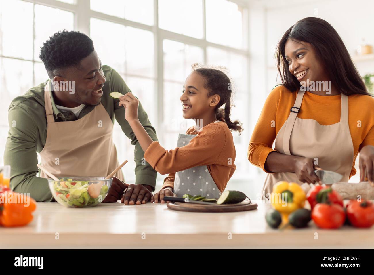 African Family Cooking, Girl Feeding Father Having Fun In Kitchen Stock ...