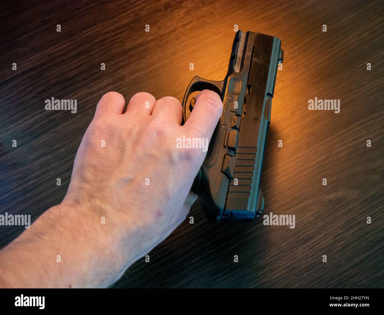Top view of hand gun on black background Stock Photo - Alamy