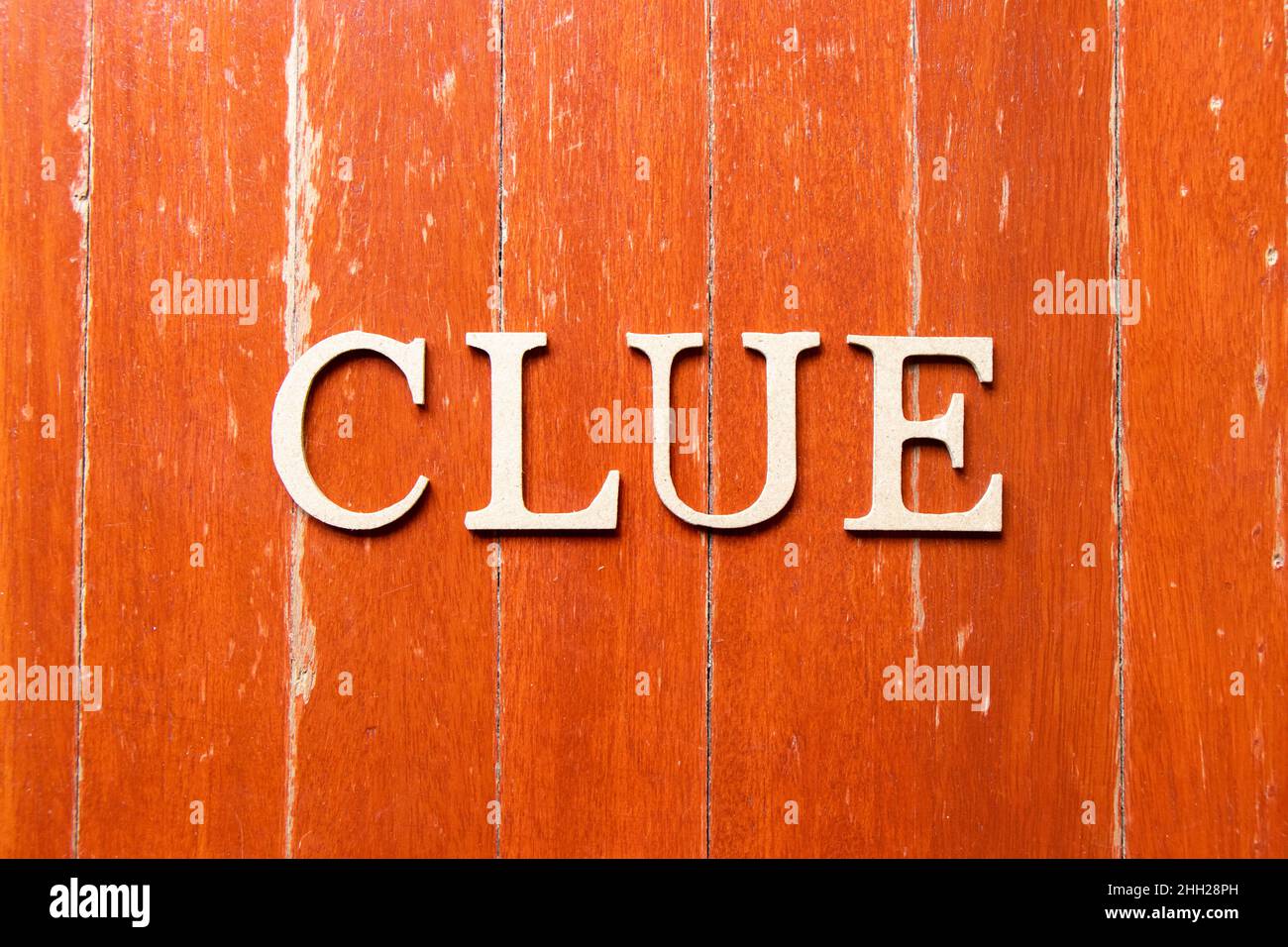 Alphabet letter in word clue on old red color wood plate background ...