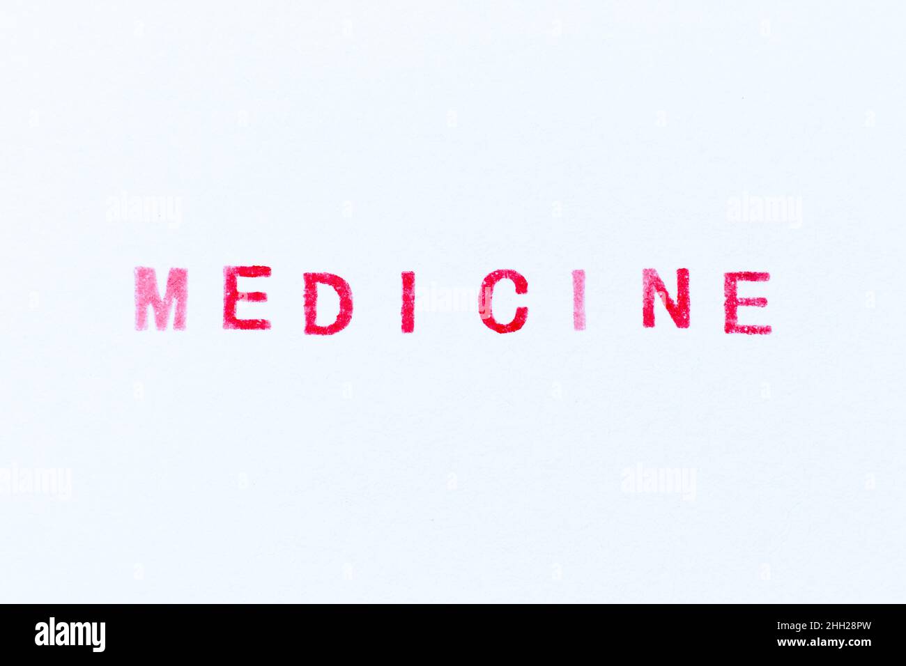 Red color ink rubber stamp in word medicine on white paper background ...