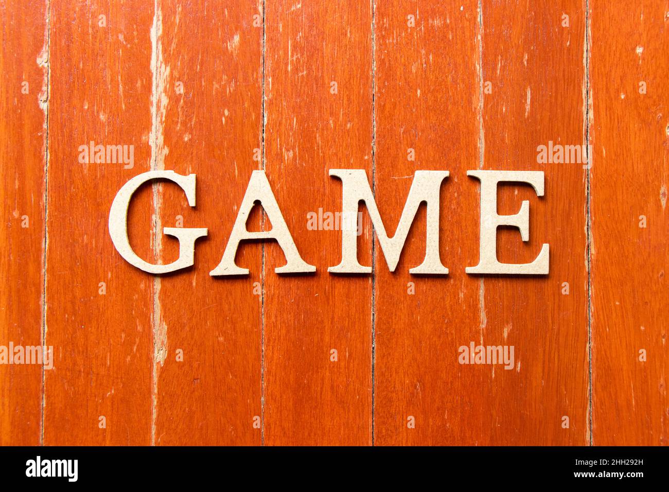 Alphabet letter in word game on old red color wood plate background ...