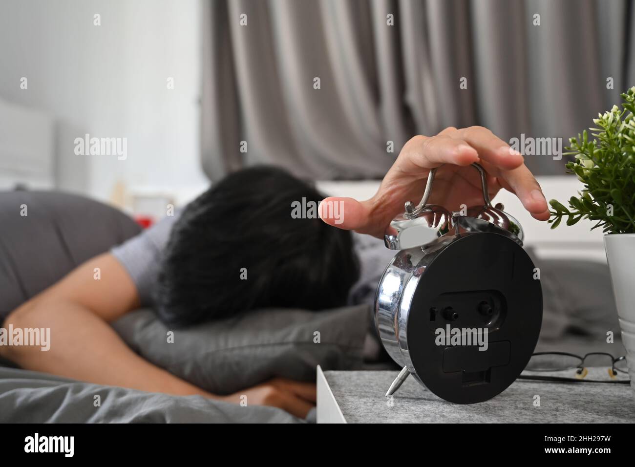 Man alarm clock switch off hi-res stock photography and images - Alamy