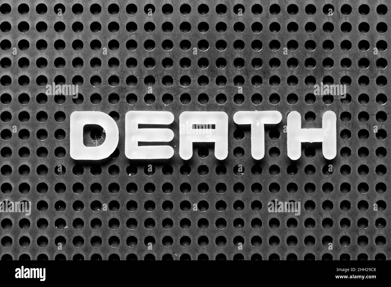 White alphabet letter in word death on black pegboard background Stock ...