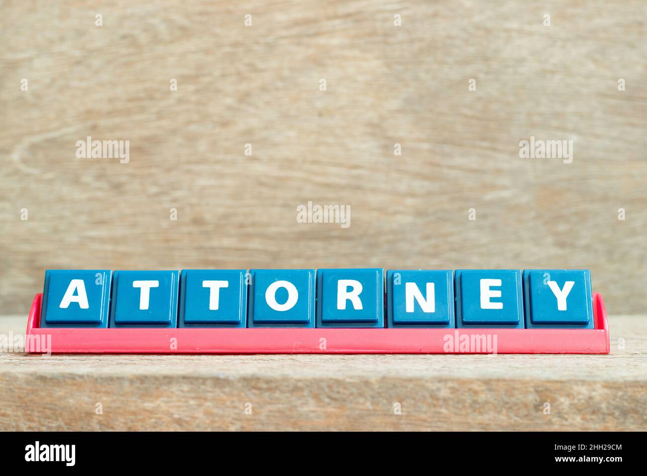Tile alphabet letter with word attorney in red color rack on wood ...