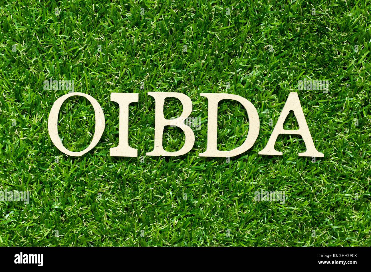 Wood letter in word OIBDA (Abbreviation of Operating Income Before ...