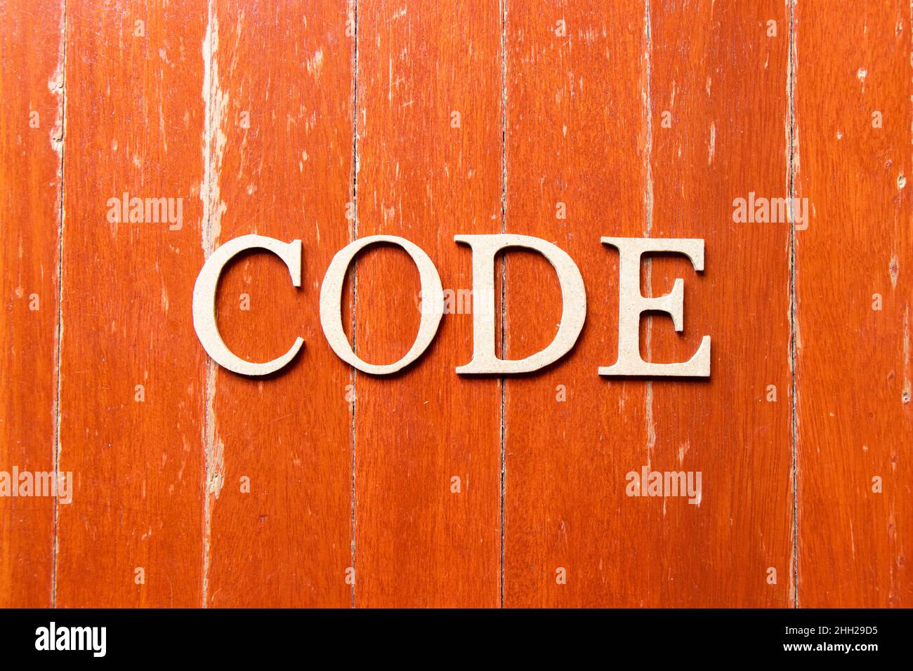 Alphabet letter in word code on old red color wood plate background ...