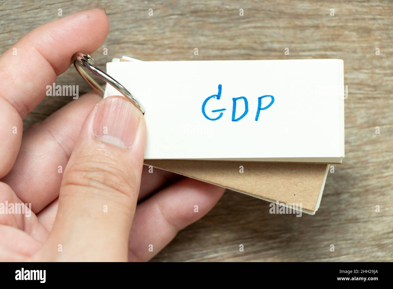 Man hold the flash card with handwriting word GDP (Abbreviation of good ...