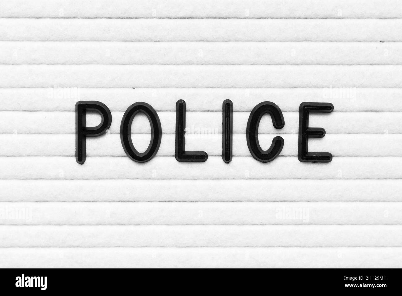 Black alphabet letter in word police on white felt board background ...