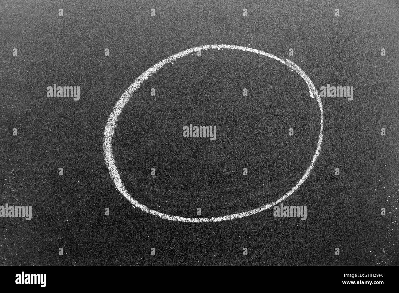 White chalk hand drawing as circle shape on black board background ...