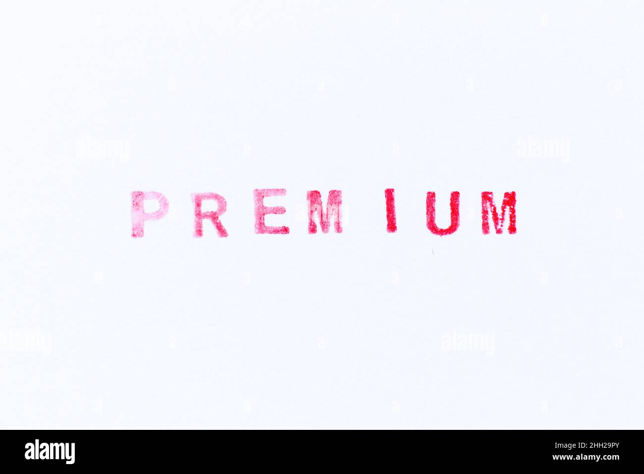 Red color ink rubber stamp in word premium on white paper background ...