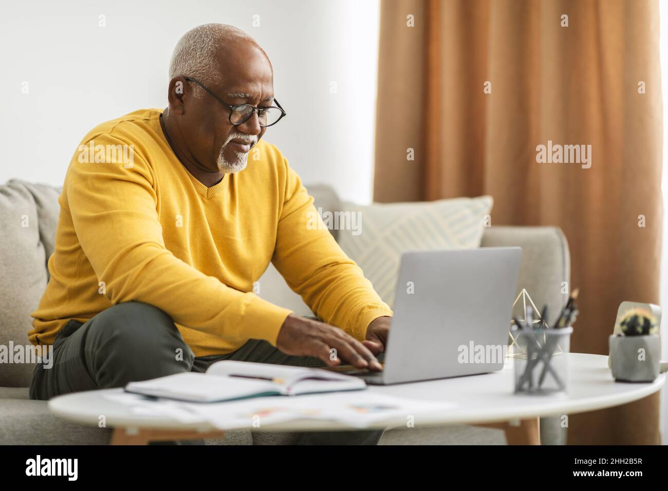 Senior Black Man Typing On Laptop Working Online Indoor Stock Photo - Alamy