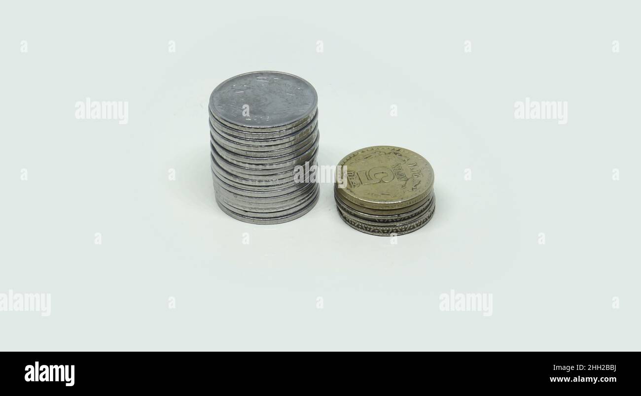 Pile of Indian Rupee Coins. Two rupee and five rupee coins. On a white ...