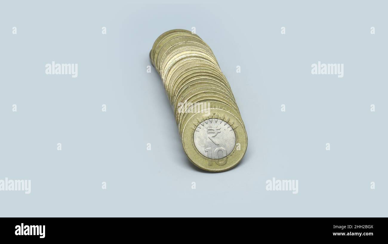 Pile of Indian Rupee Coins. Ten rupee coins stacked. On a white ...