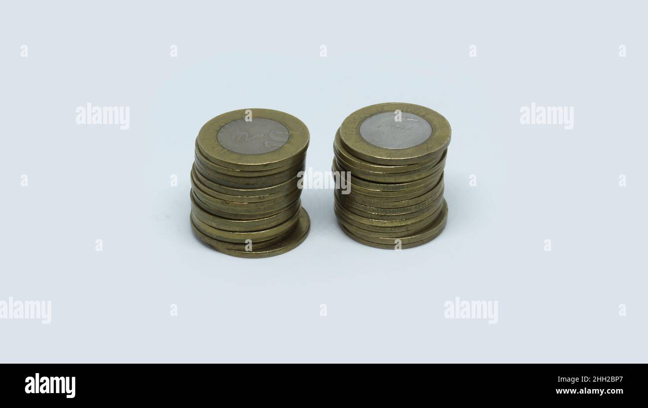 Pile of Indian Rupee Coins. Ten rupee coins stacked in two layers. On a ...