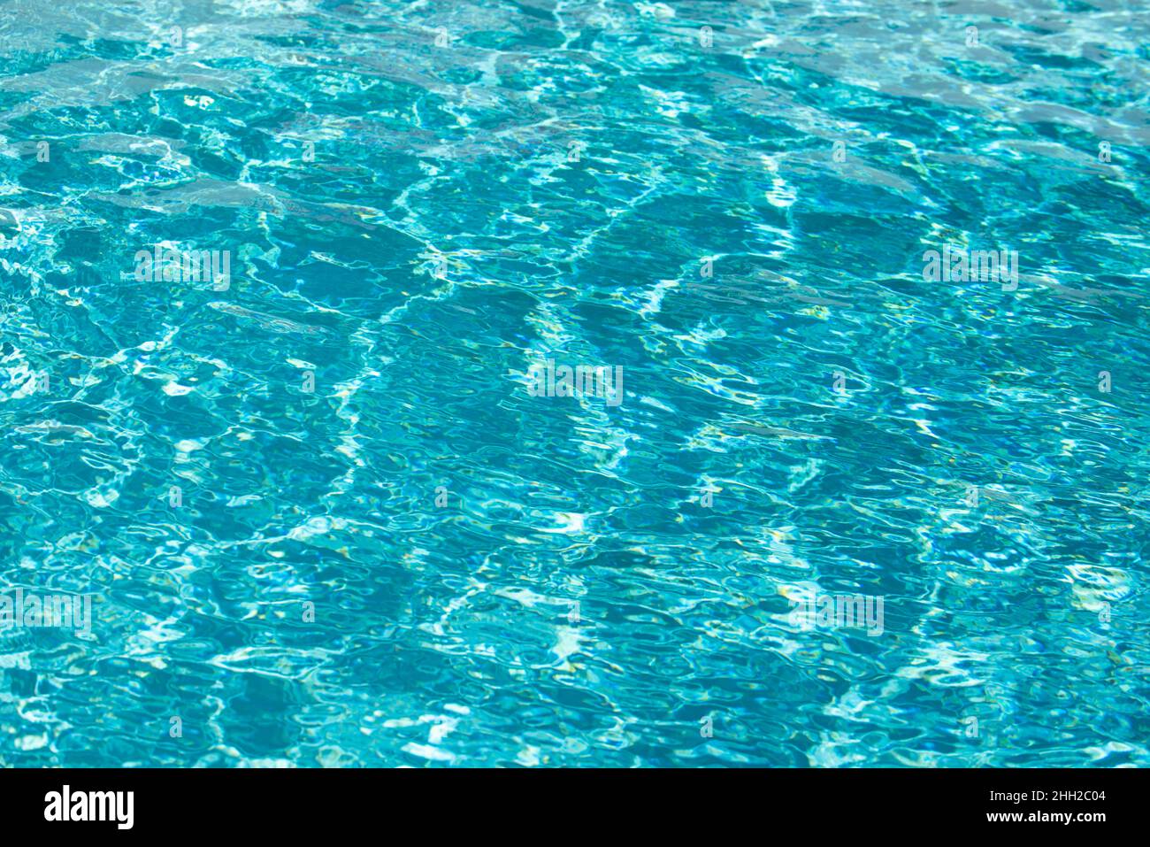 Background of blue water in swimming pool with sun reflection, ripple ...