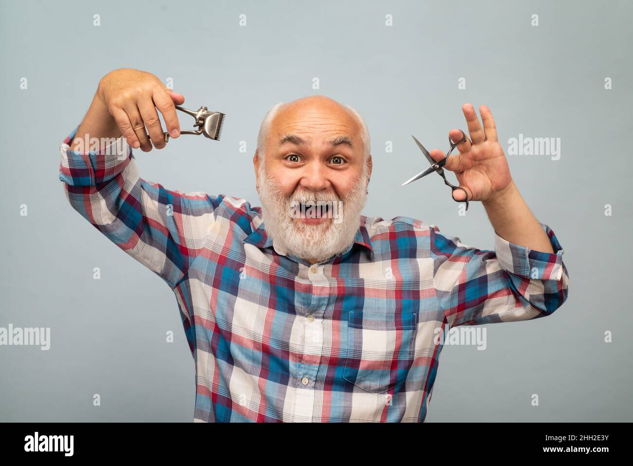 Portrait of barber with scissors and straight razor hair clipper ...