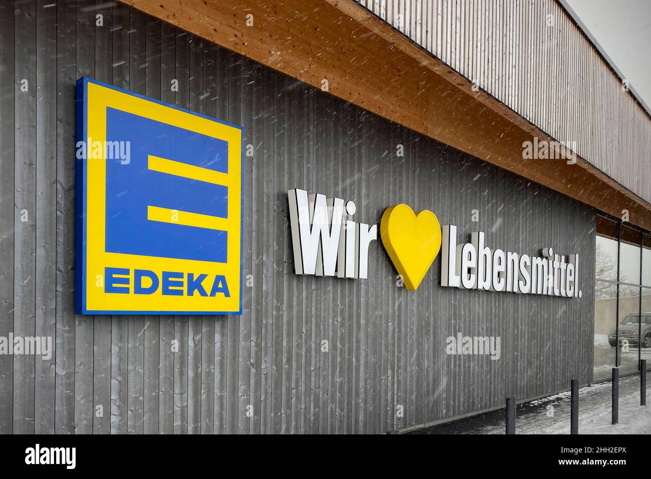 EDEKA company logo with the slogan WE LIVE FOOD at a branch, market in ...