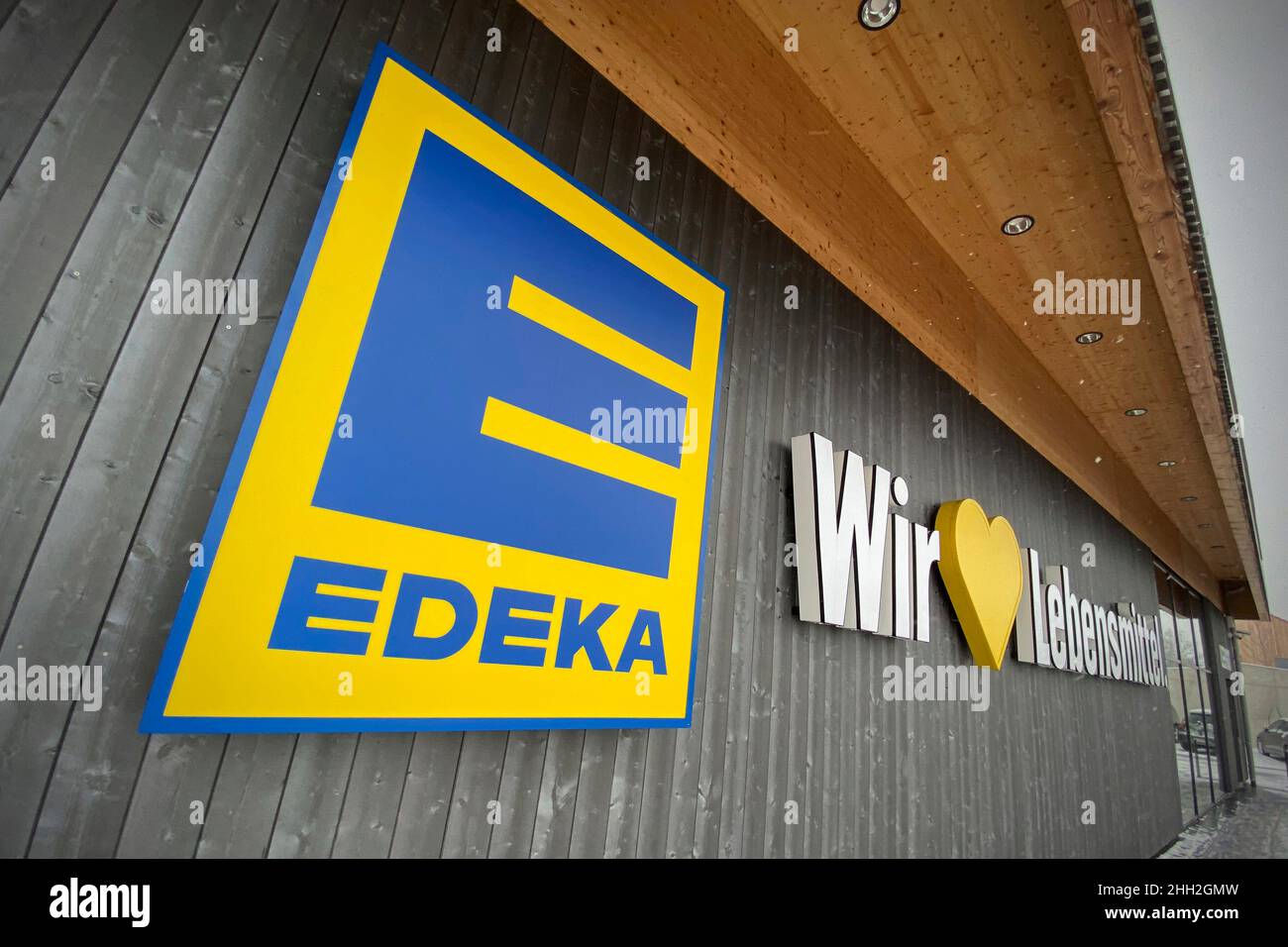 EDEKA company logo with the slogan WE LIVE FOOD at a branch, market in ...